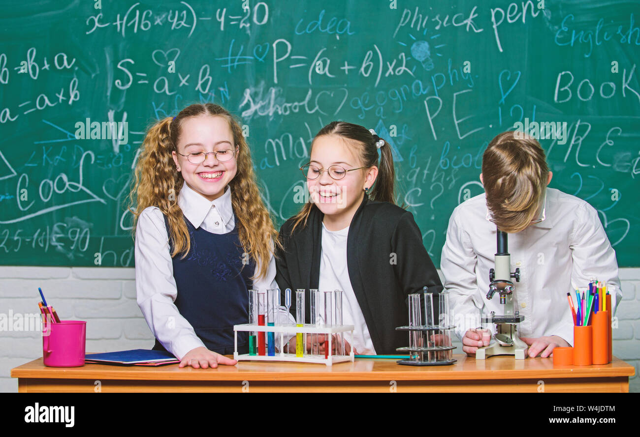 Little children at laboratory. Chemistry microscope. students do ...
