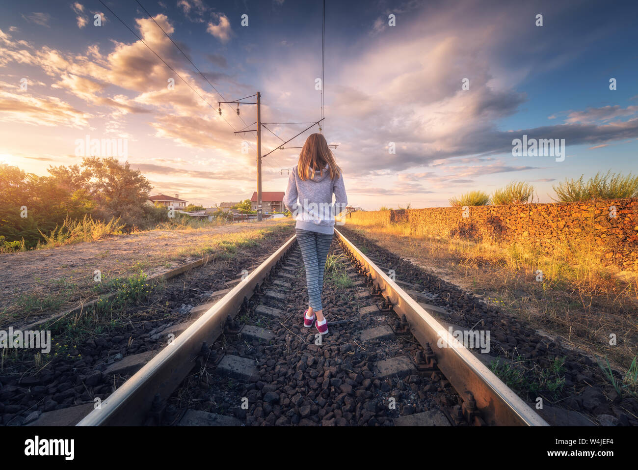 Girl standing on railroad track hi-res stock photography and images - Alamy
