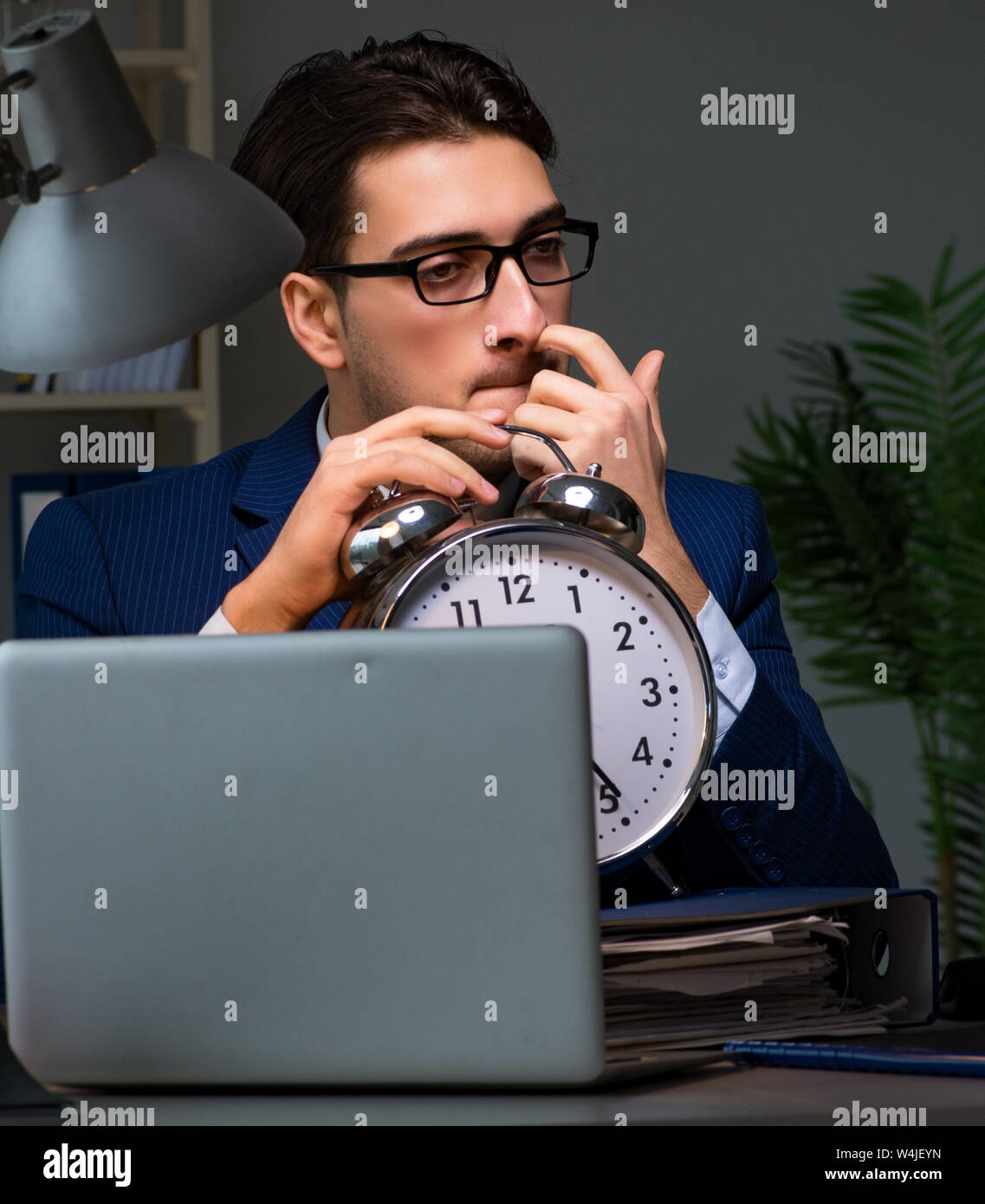 Employee staying late to finish work on auditing Stock Photo - Alamy