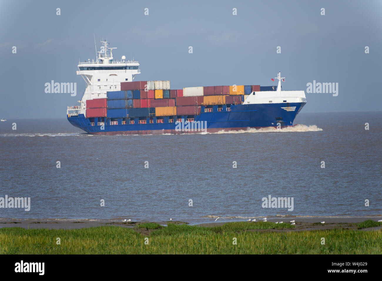 A container ship trading worldwide at sea Stock Photo - Alamy