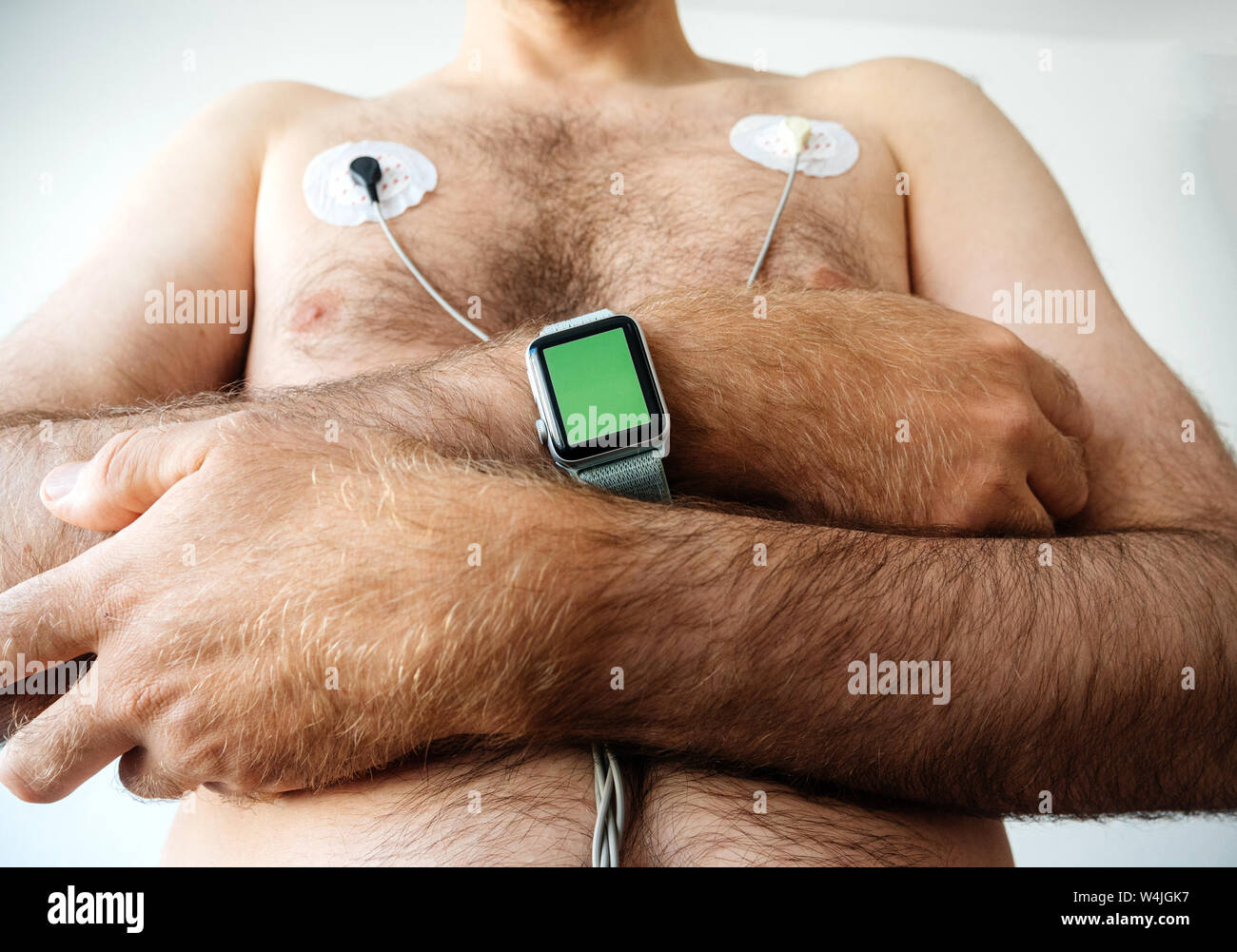 Man setting green screen smartwatch wearing a heart monitor holter ...