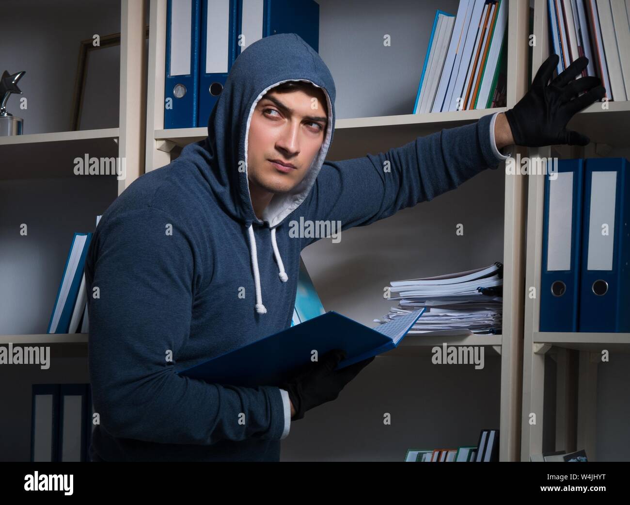 Young man in industrial espionage concept Stock Photo - Alamy