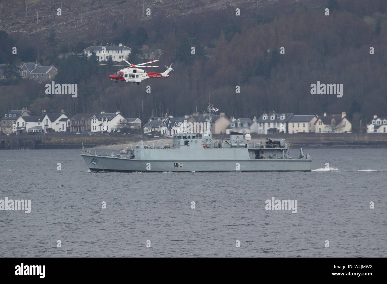 An HM Coastguard helicopter (G-MCGT), and the Royal Navy minehunter HMS ...