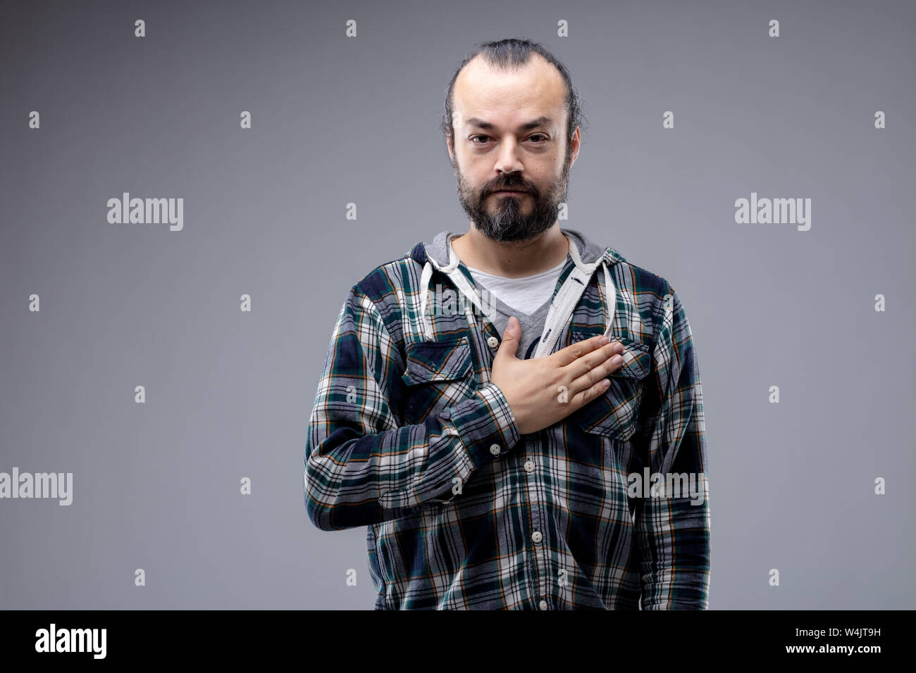 Patriotic or sincere honest man placing a hand on his heart with an ...