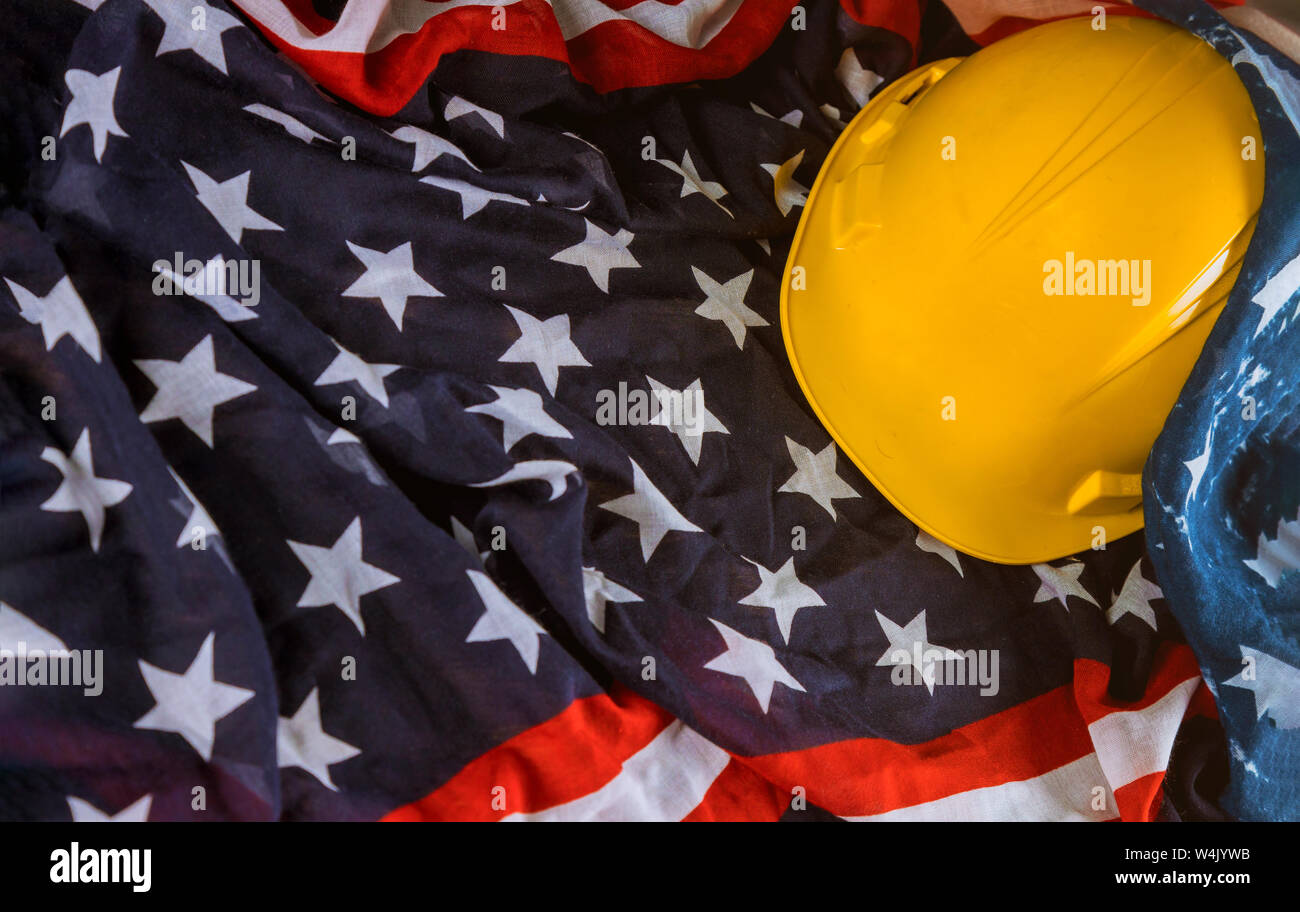 Construction yellow helmet and american flags with copy space for Labor ...