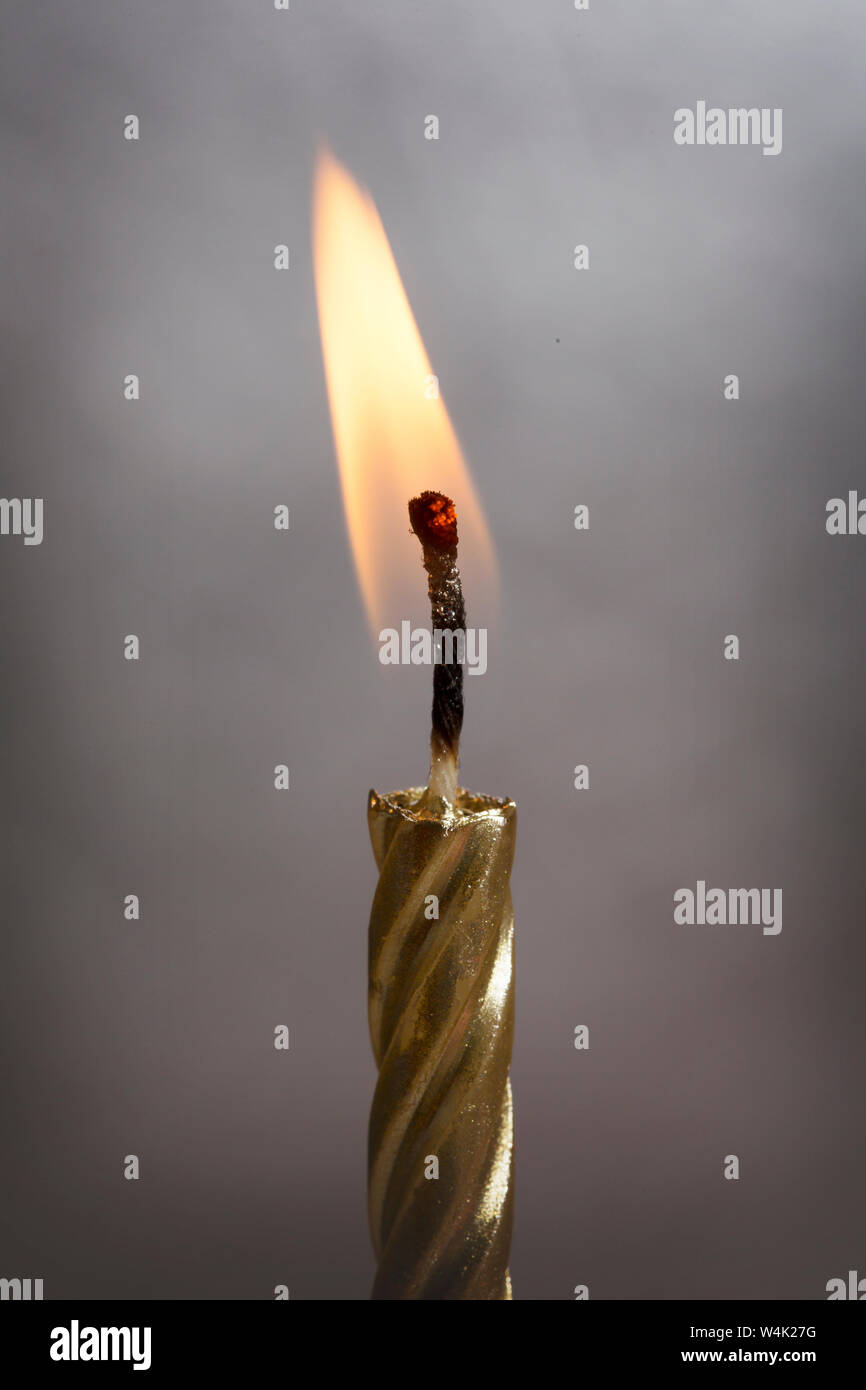 Single Burning Gold Candle Stock Photo - Alamy