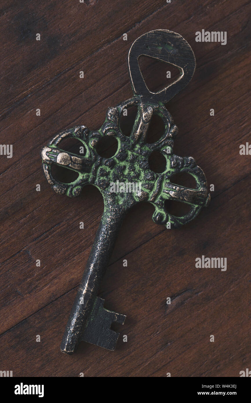 Old Skeleton Key with blue patina on a wood background Stock Photo - Alamy