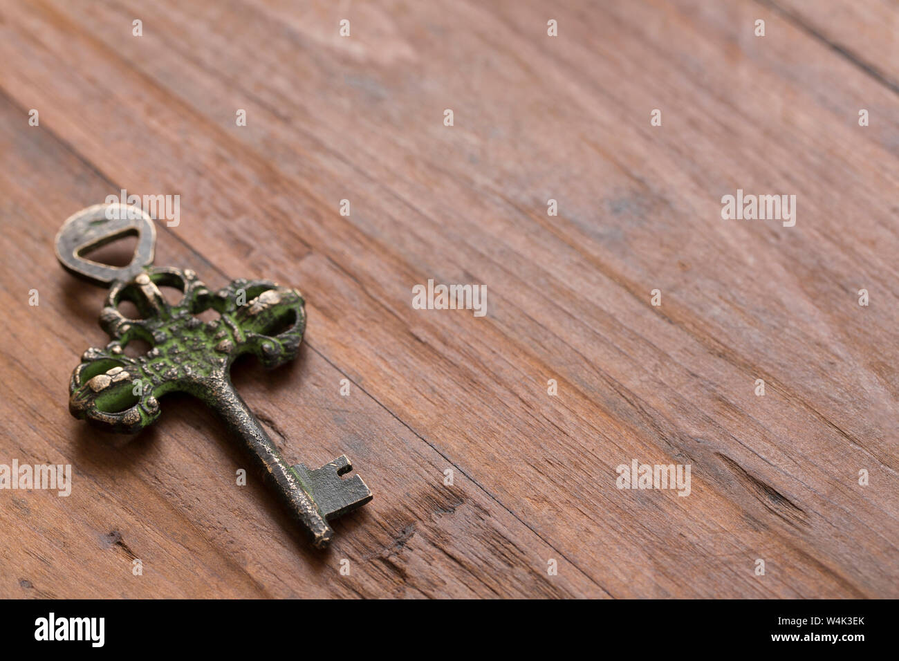 Old Skeleton Key with blue patina on a wood background Stock Photo - Alamy