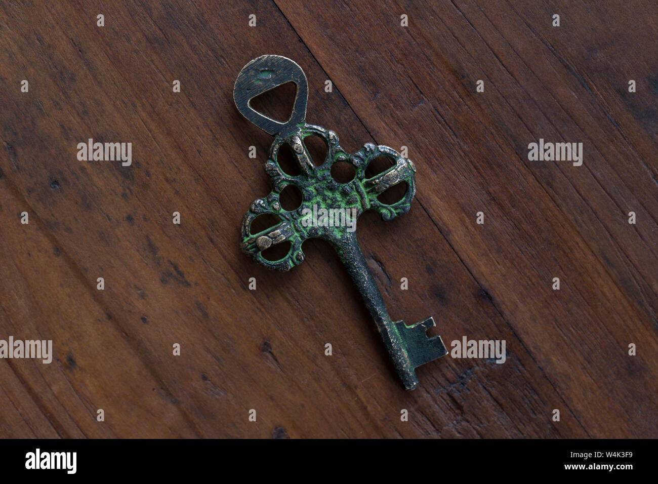 Old Skeleton Key with blue patina on a wood background Stock Photo - Alamy