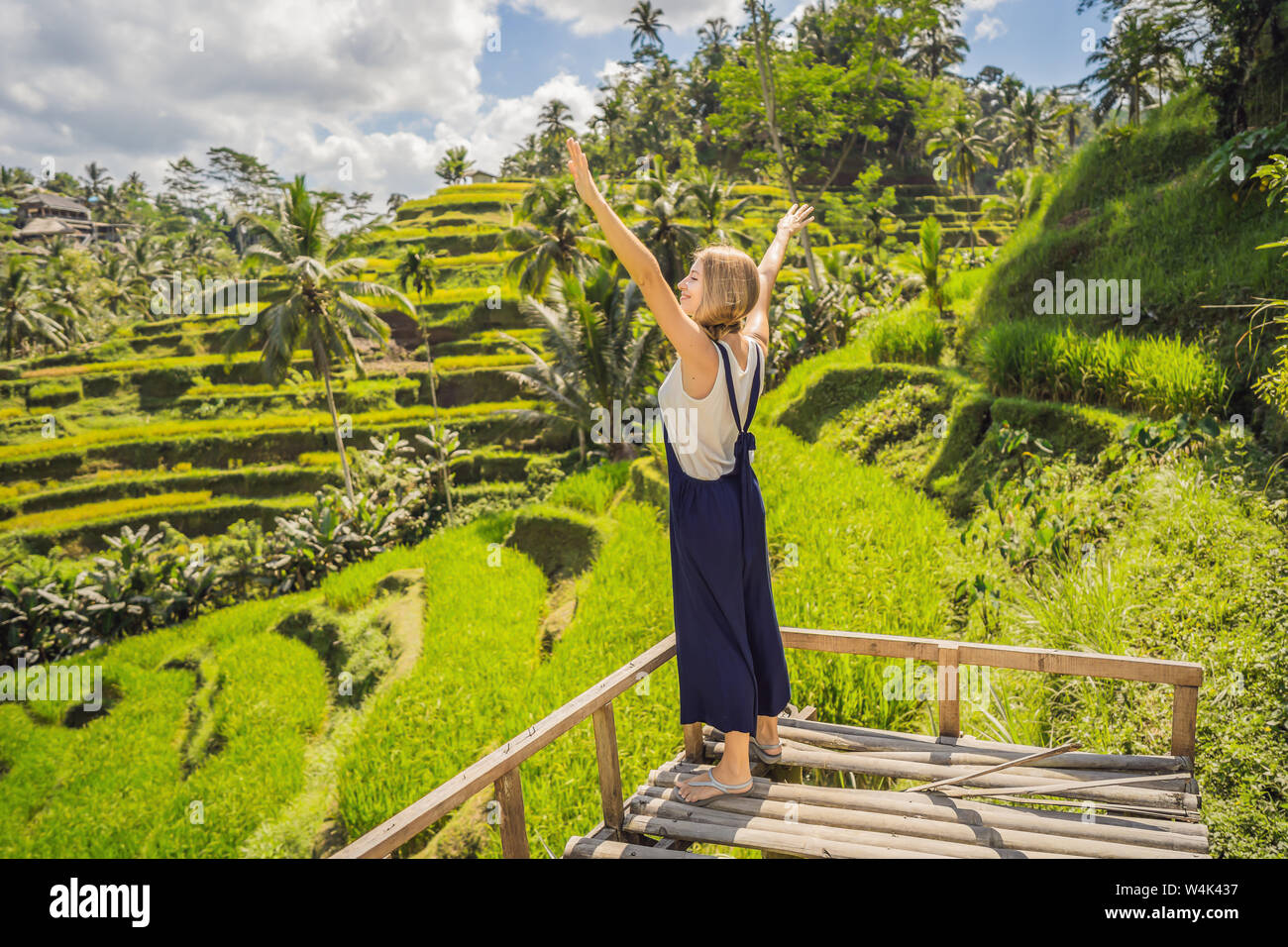 Beautiful young woman walk at typical Asian hillside with rice farming ...
