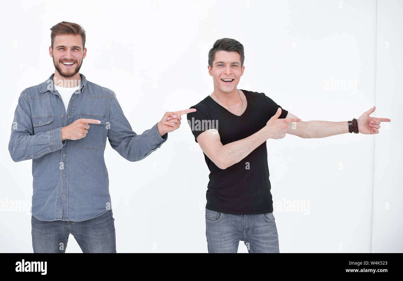 Standing young people pointing a finger in each hand Stock Photo - Alamy