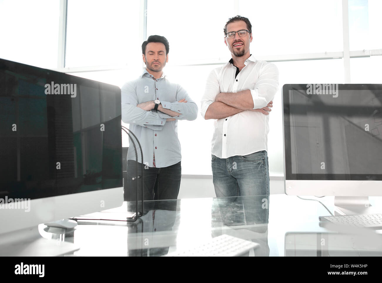 two employees standing in a modern office Stock Photo - Alamy