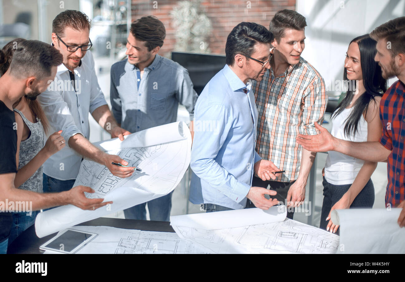 group of designers and architects discussing new sketches Stock Photo ...
