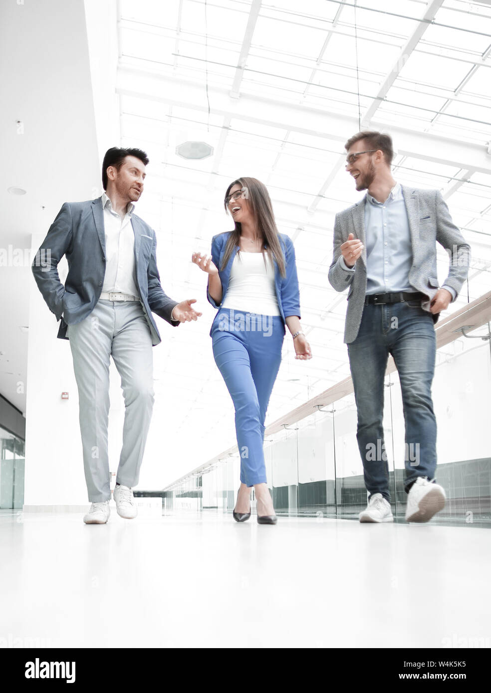 Business people walking in the office corridor Stock Photo - Alamy