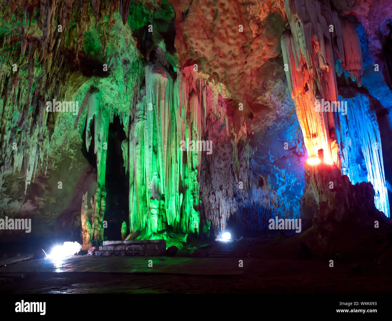 Stalactite wall illuminated with color light in Tham Khao Bin cave ...