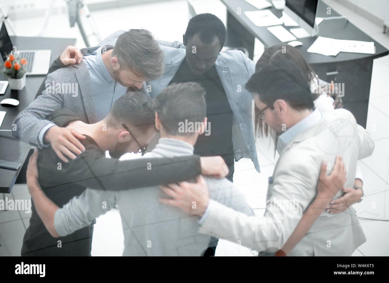 close up.business team hugging each other Stock Photo - Alamy