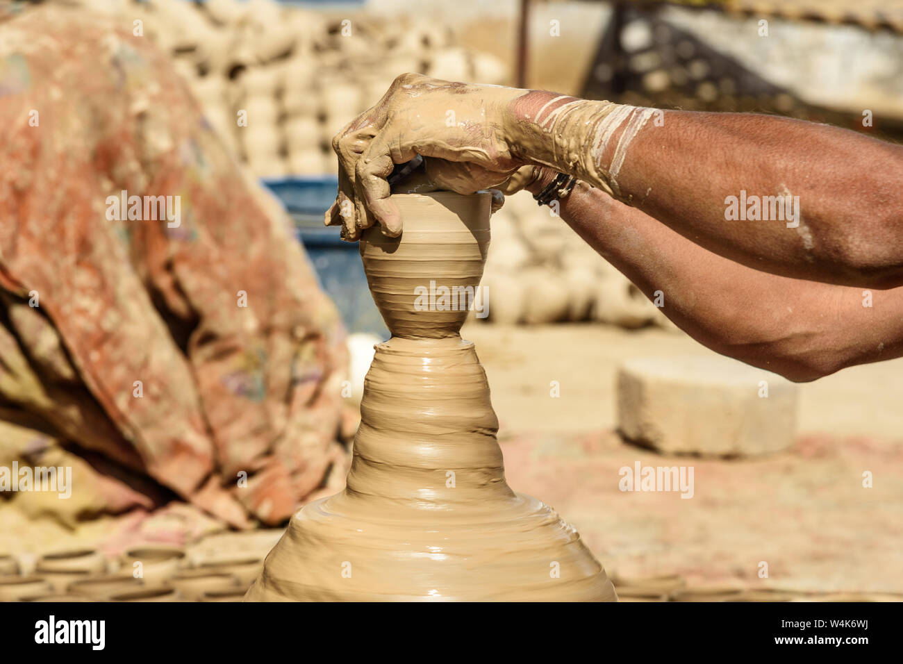 Indian potter making clay pots on pottery wheel in Bikaner. Rajasthan ...