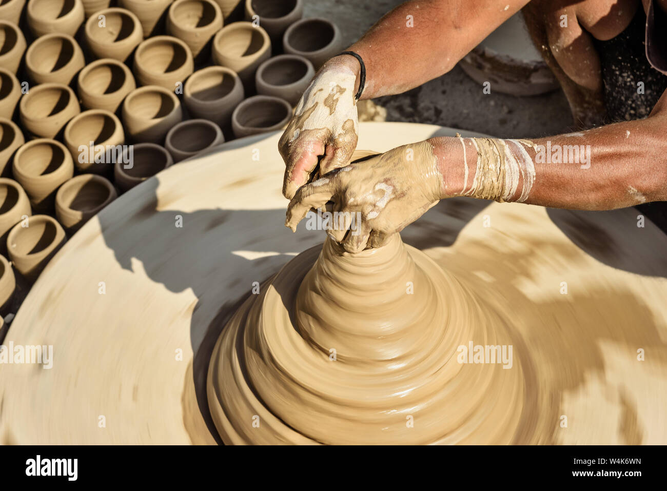Indian potter making clay pots on pottery wheel in Bikaner. Rajasthan ...
