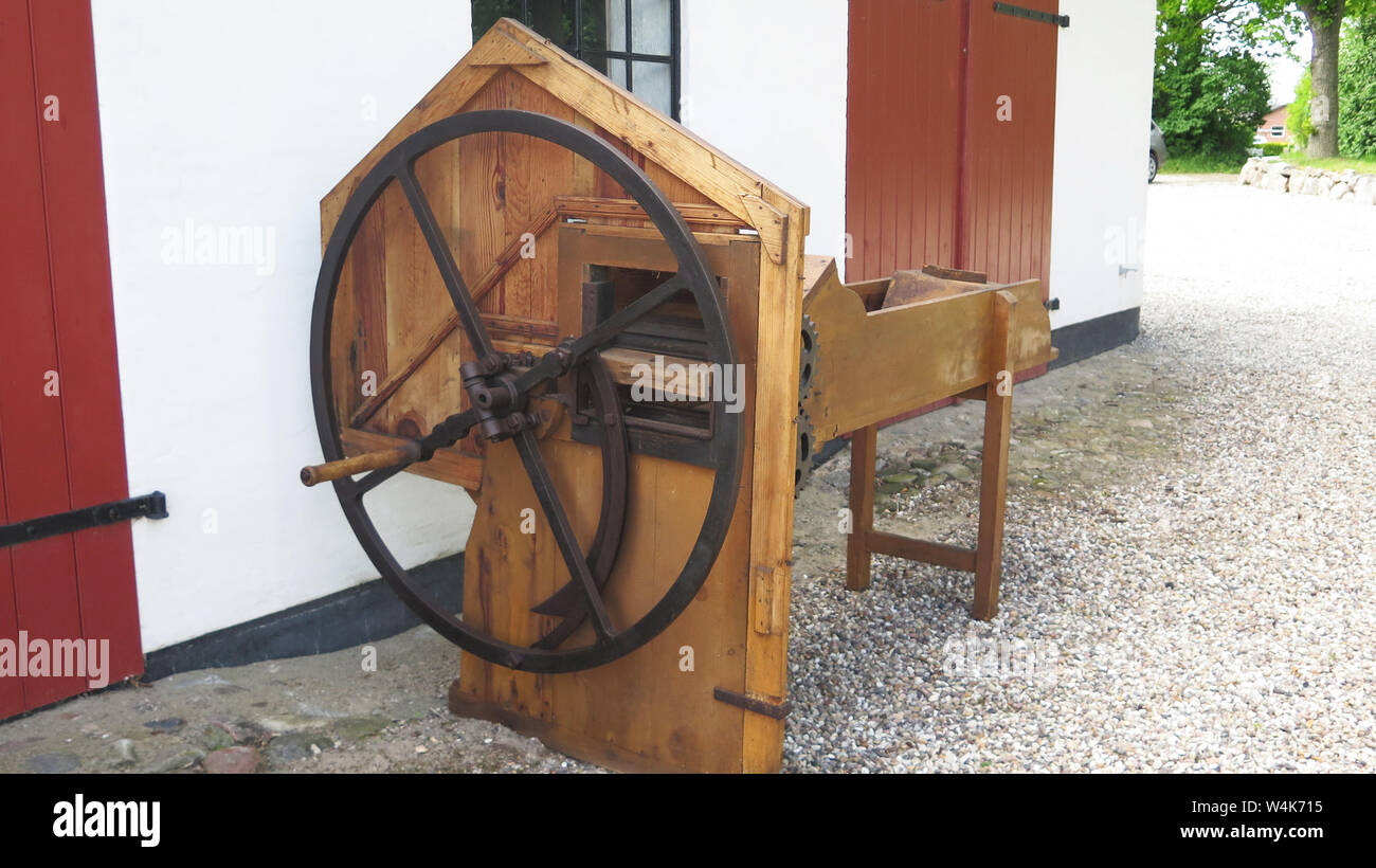 Hand operated wooden straw cutter on display in southern Danish farm ...