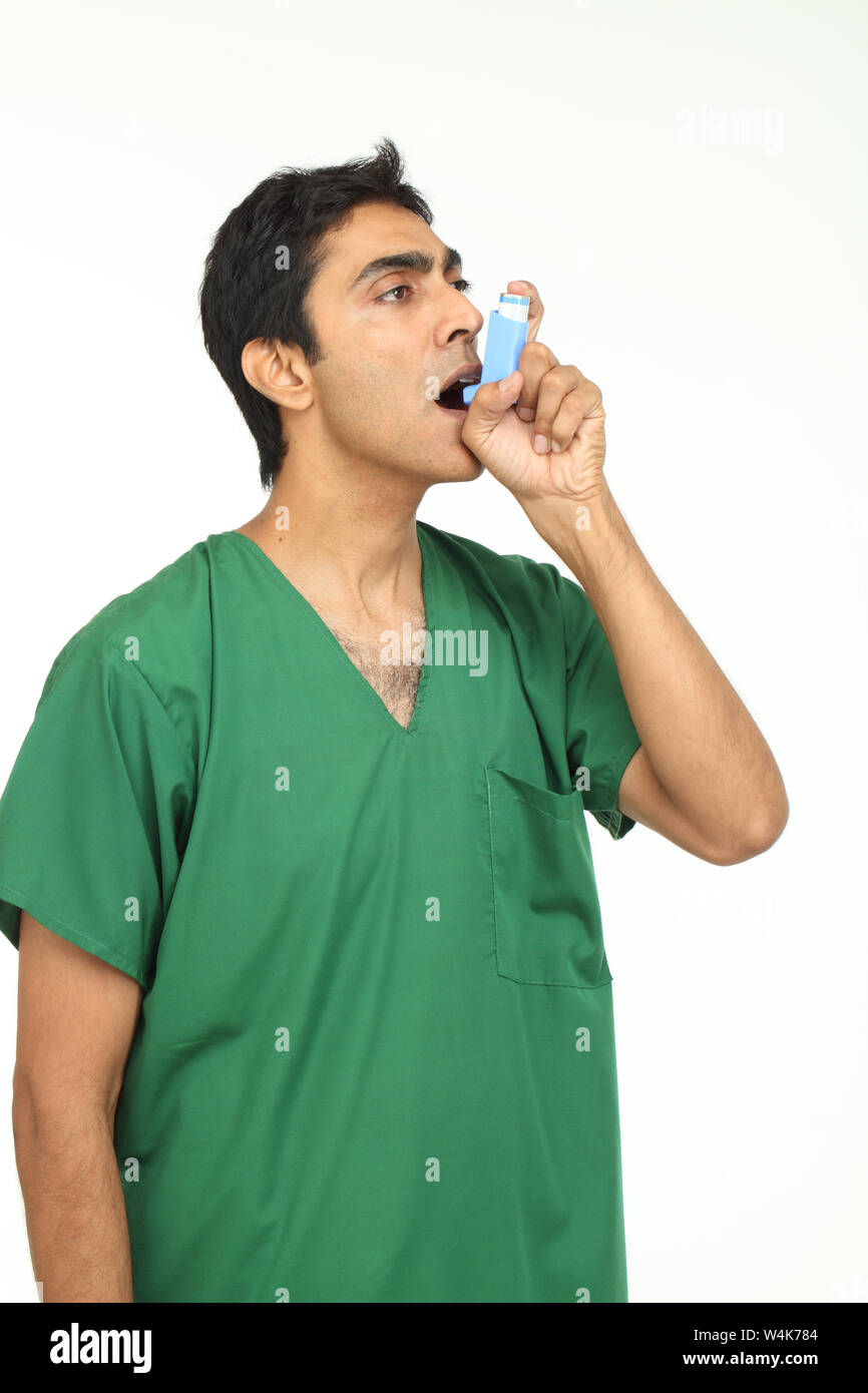 Patient using asthma inhaler Stock Photo - Alamy