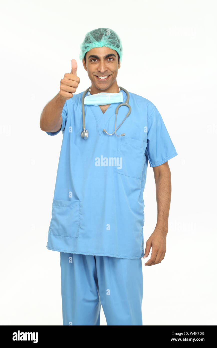 Male surgeon showing thumbs up sign and smiling Stock Photo - Alamy