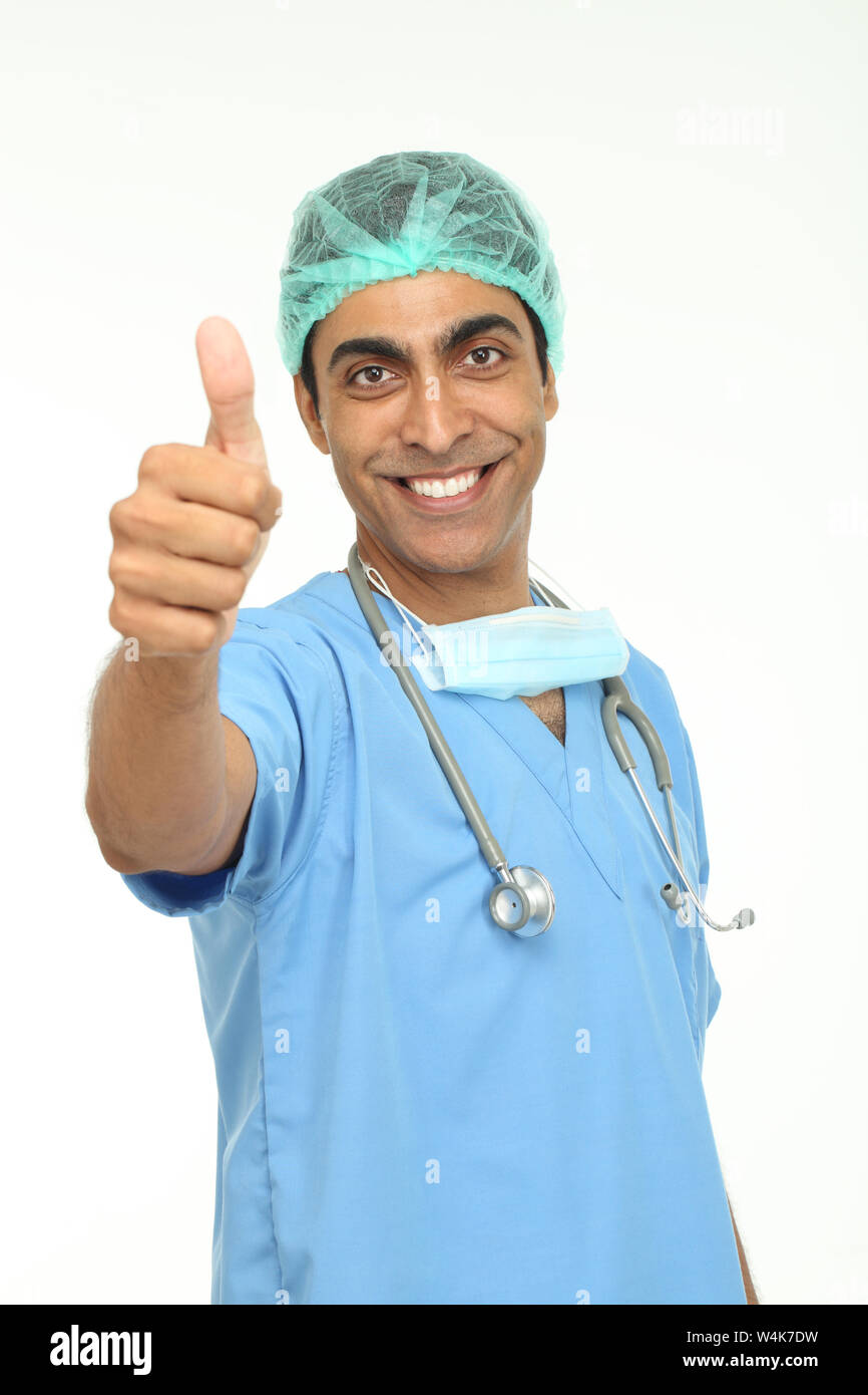 Male surgeon showing thumbs up sign and smiling Stock Photo - Alamy