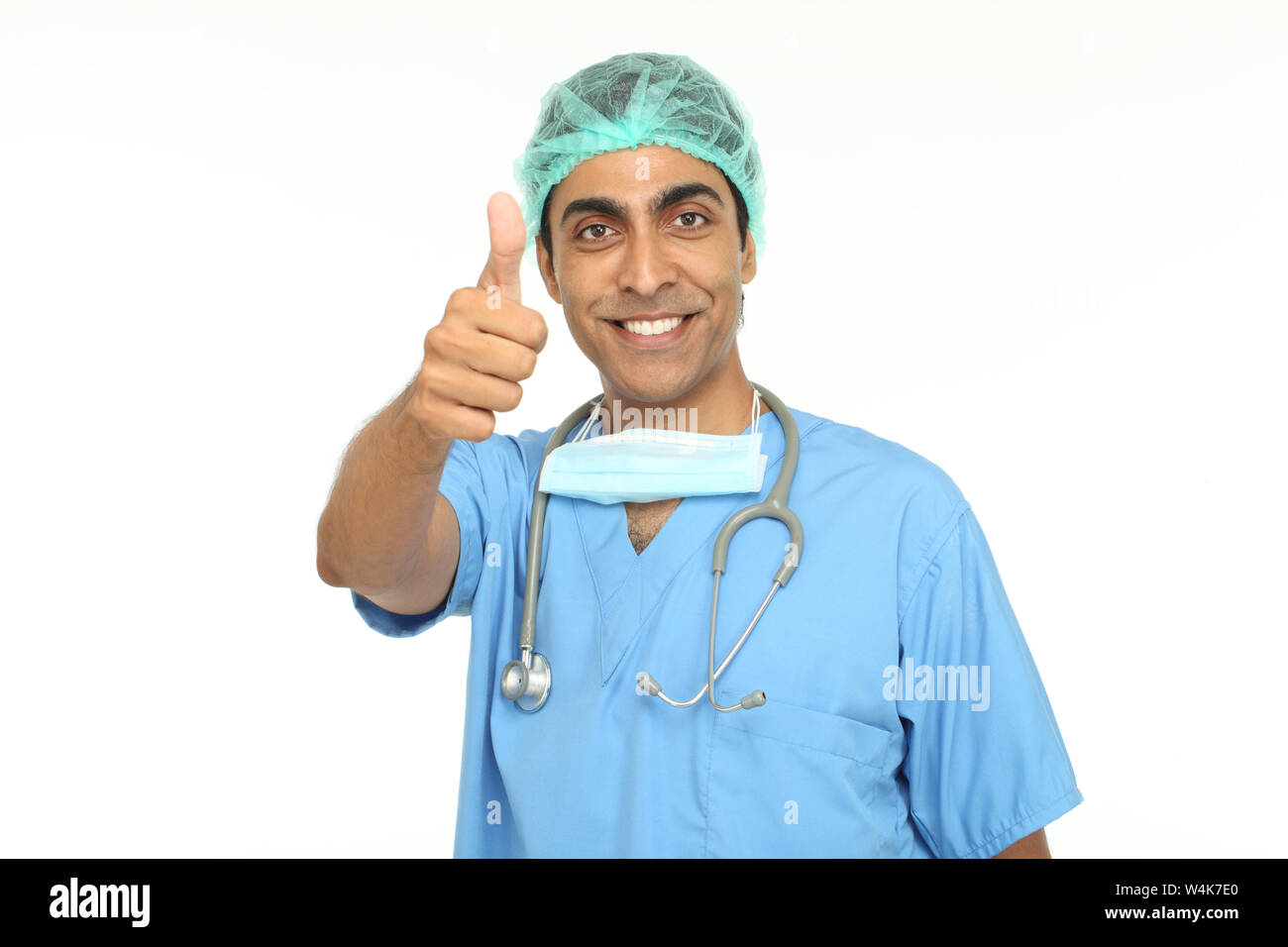 Indian male surgeon showing thumbs up sign and smiling Stock Photo - Alamy