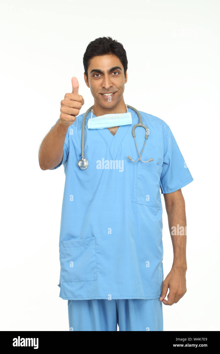 Male surgeon showing thumbs up sign and smiling Stock Photo - Alamy