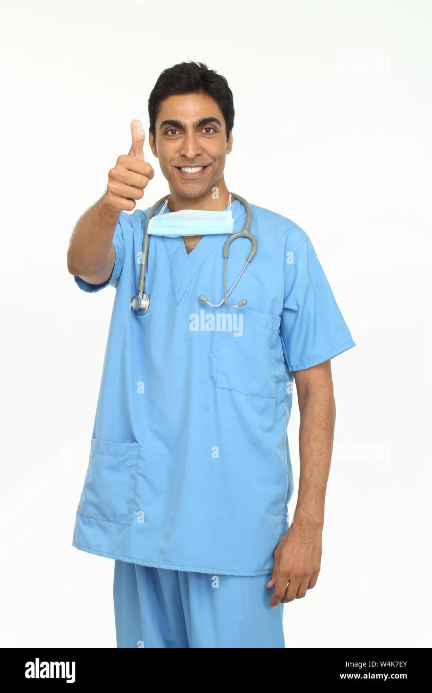 Male surgeon showing thumbs up sign and smiling Stock Photo - Alamy