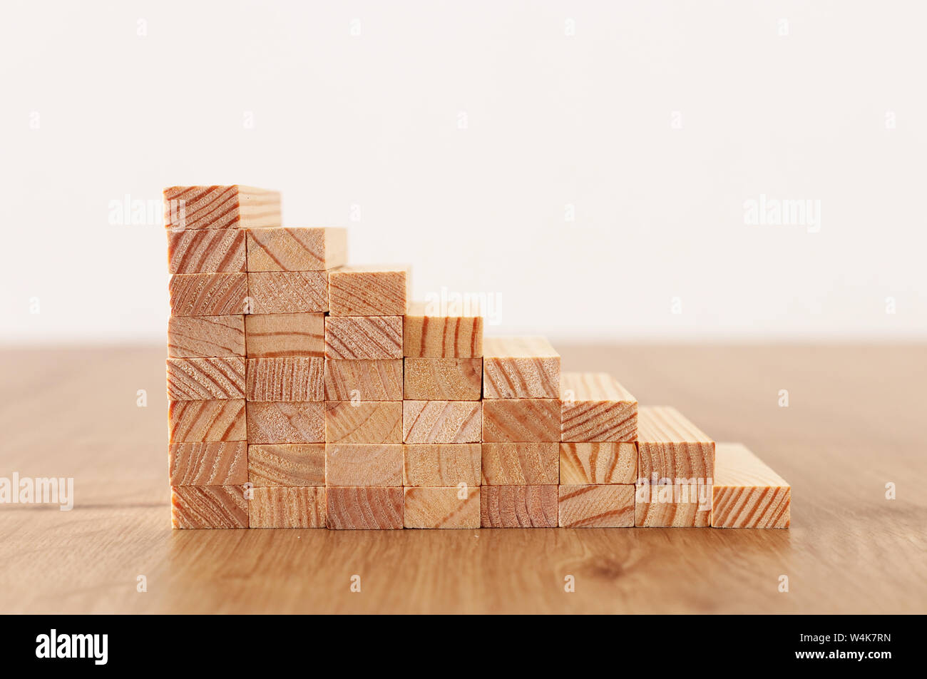 Business image of arranging wood blocks stacking as step stairs ...