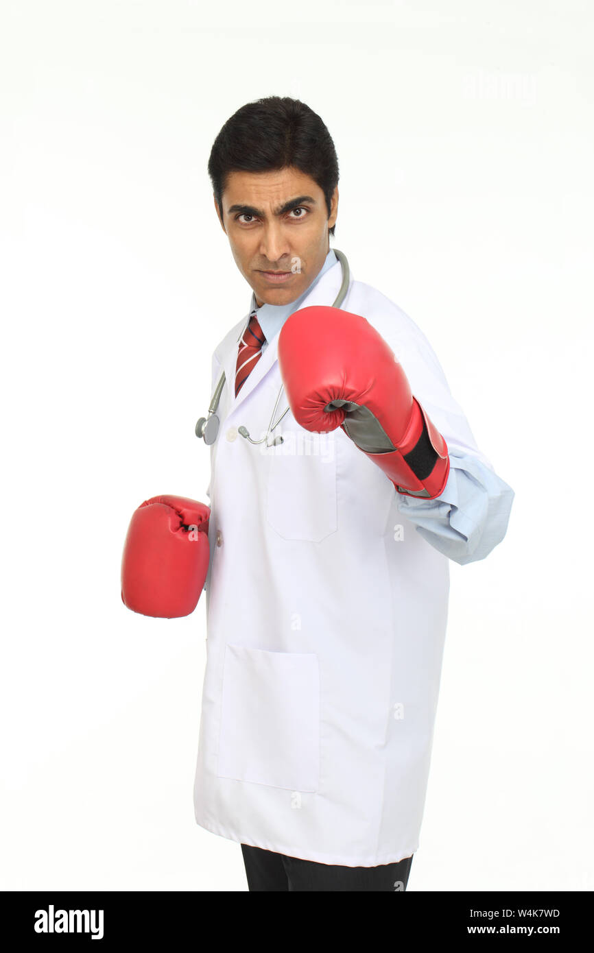 Male doctor wearing boxing gloves Stock Photo - Alamy