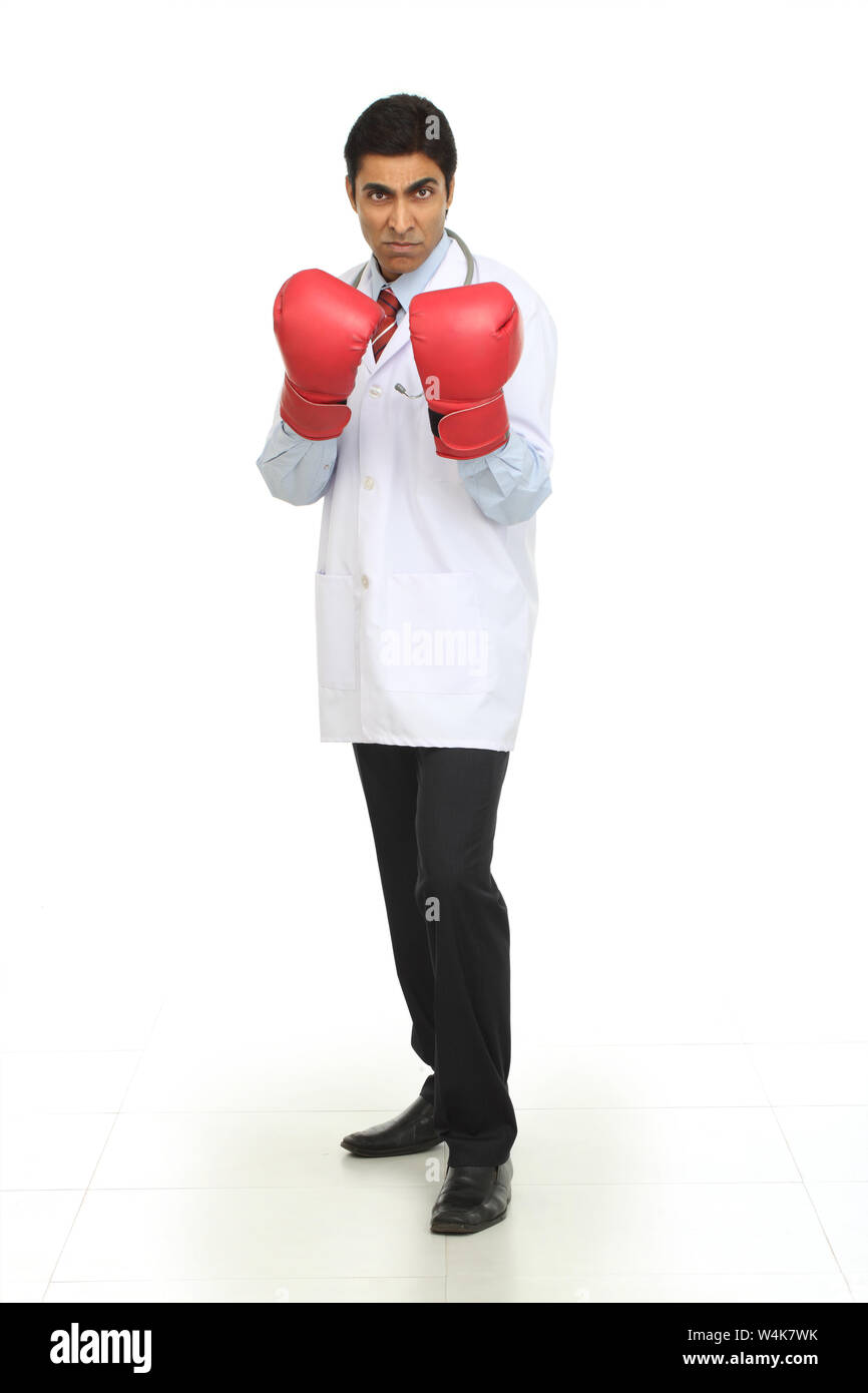 Male doctor wearing boxing gloves Stock Photo - Alamy