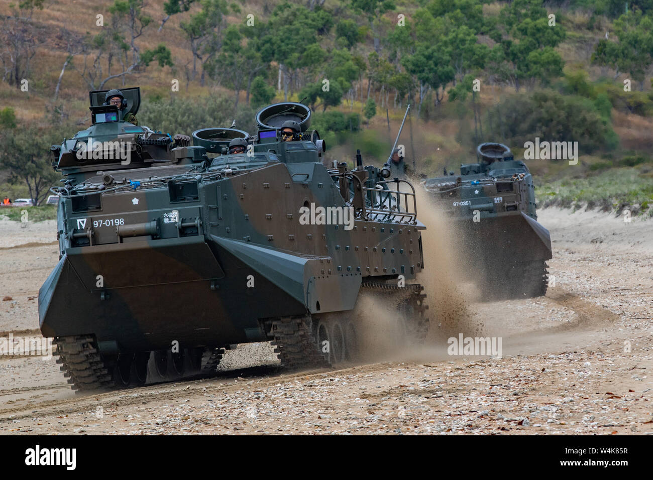 Japanese Defense Force amphibious assault vehicles move in formation on ...