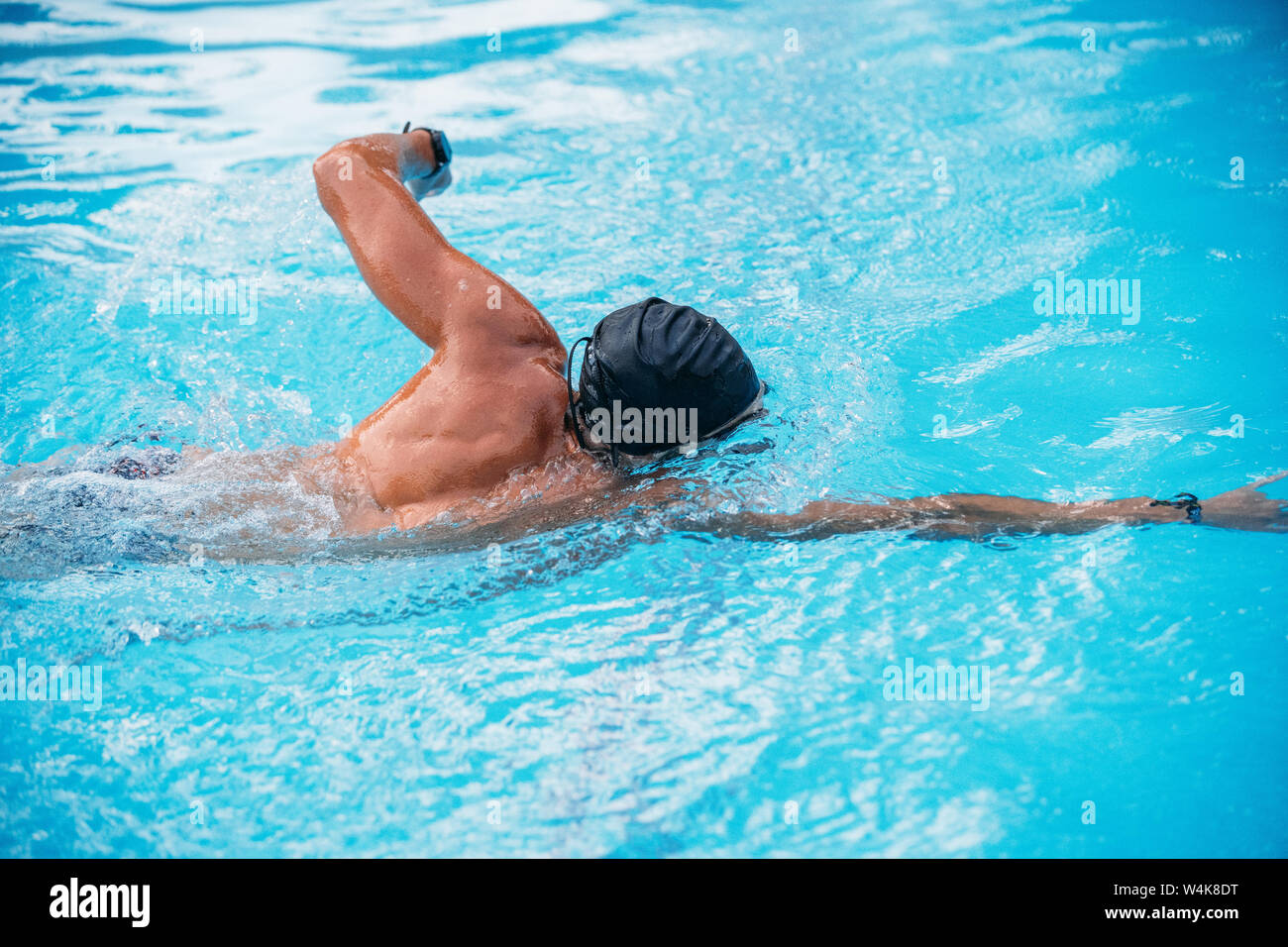Athletic Young man swimming the back crawl in a pool. Swimming ...