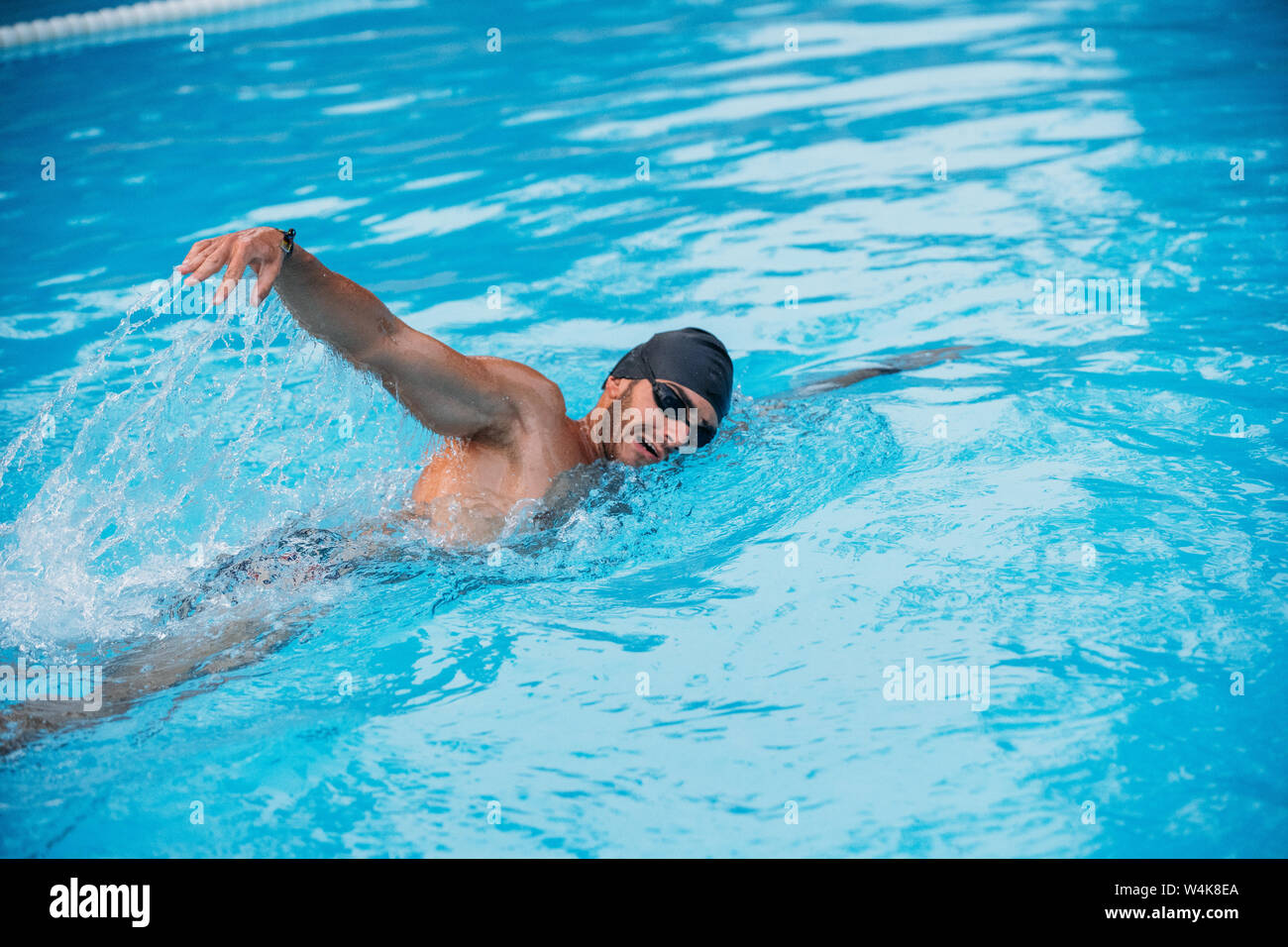 Athletic Young man swimming the front crawl in a pool. Swimming ...
