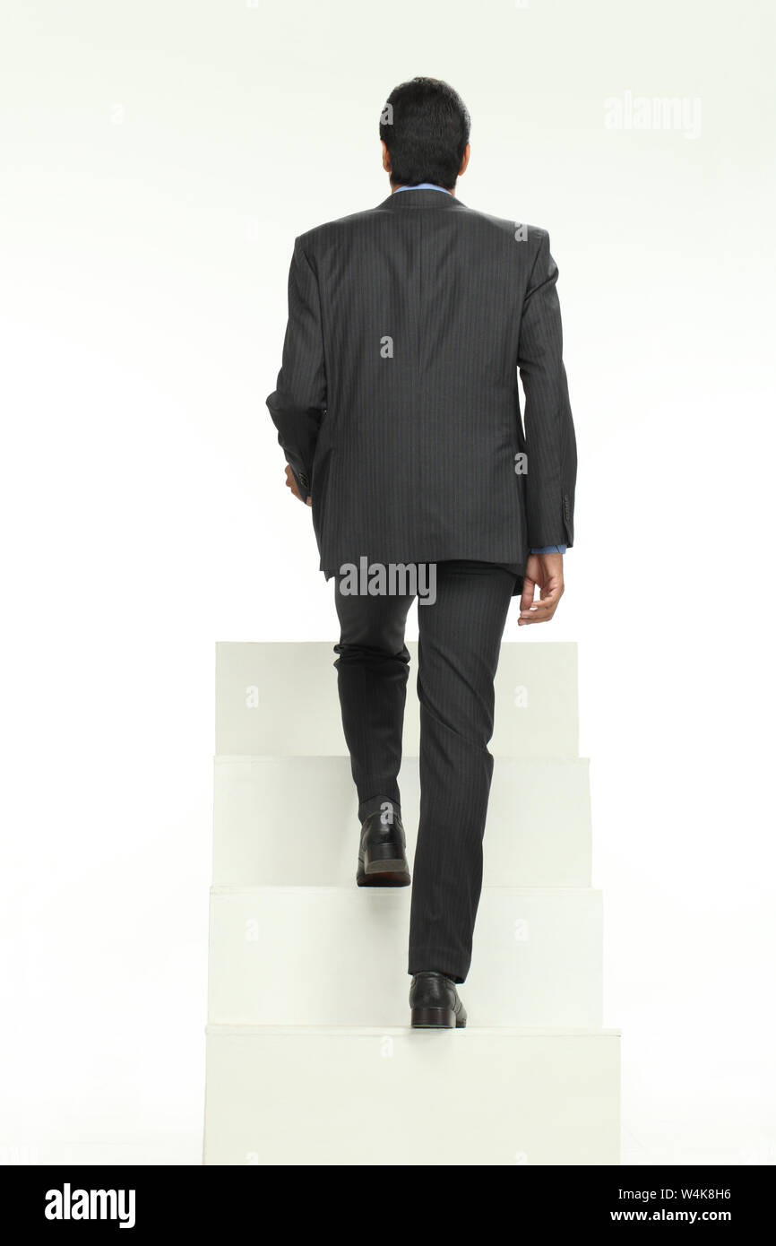 Rear view of a man walking up steps hi-res stock photography and images ...