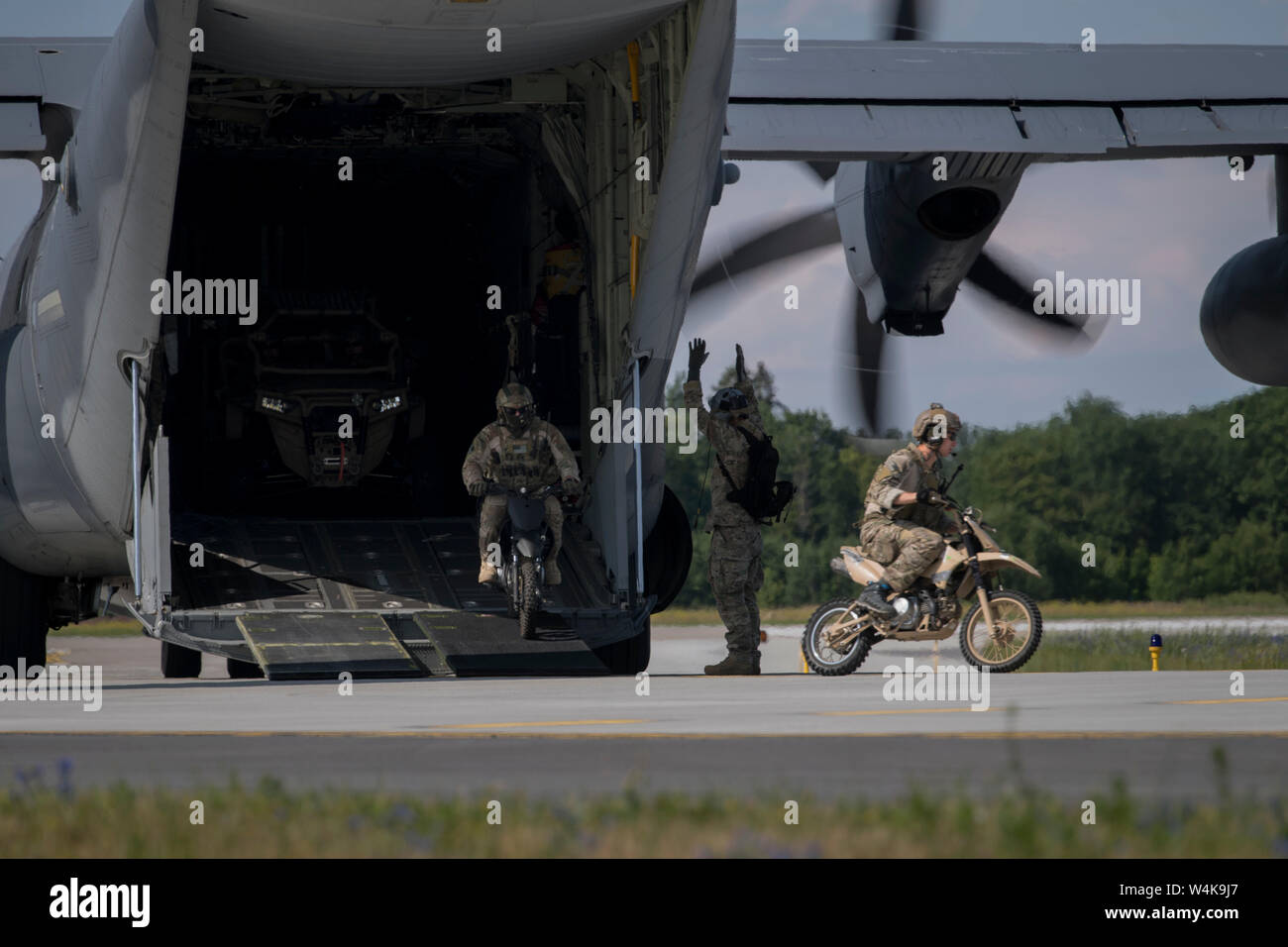U.S. Air Force Special Tactics Operators infill on tactical vehicles to ...