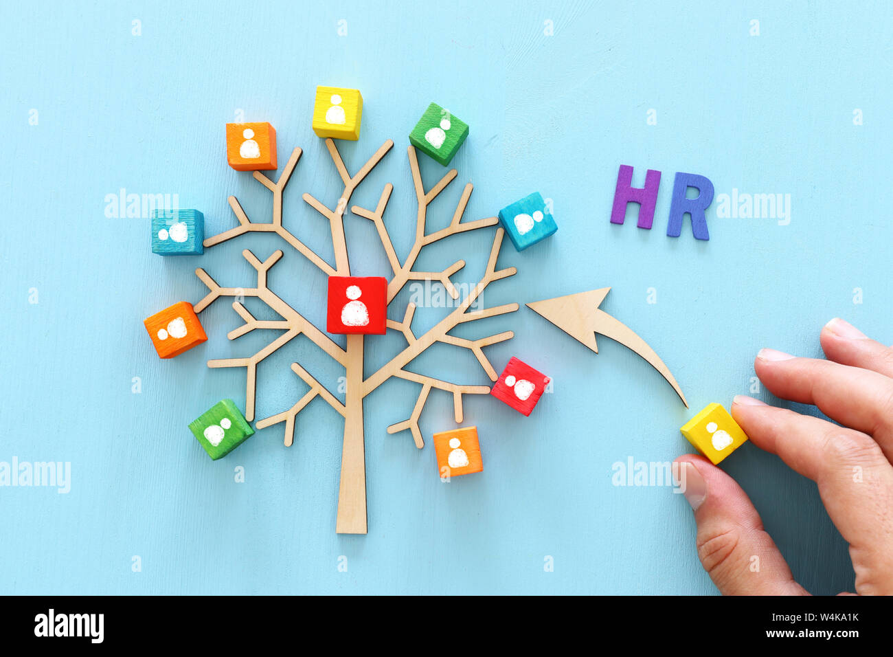 Business image of wooden tree with people icons over blue table, human ...