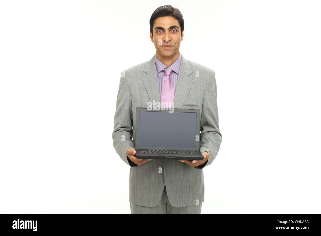 Indian businessman showing laptop Stock Photo - Alamy
