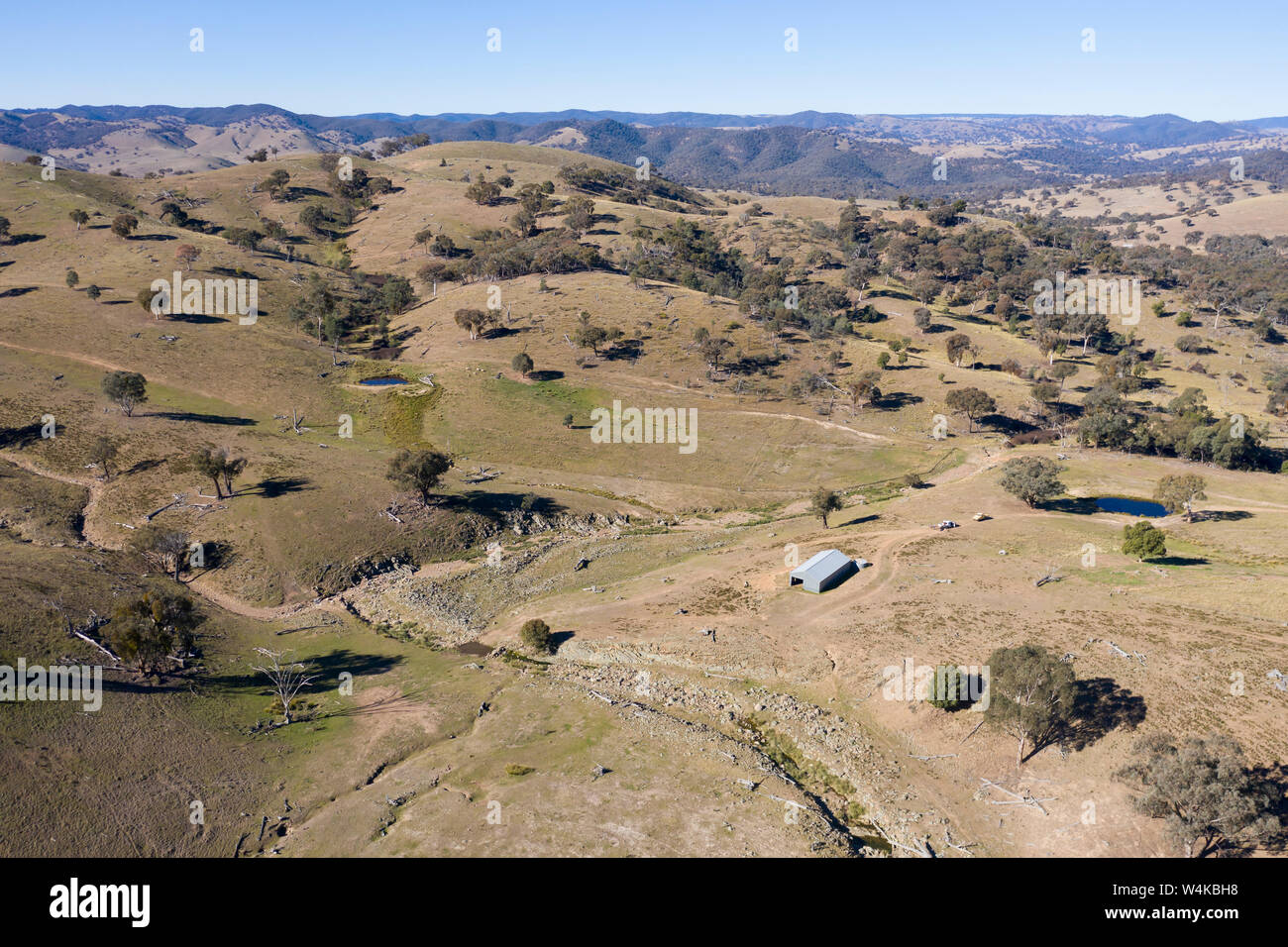 A dry creek bed running through hills in rural Australia Stock Photo ...