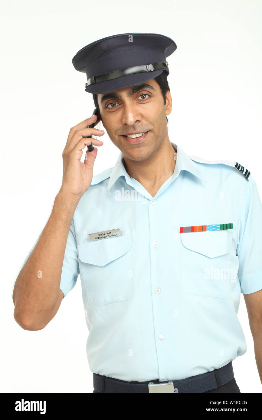 Pilot talking on a mobile phone Stock Photo - Alamy