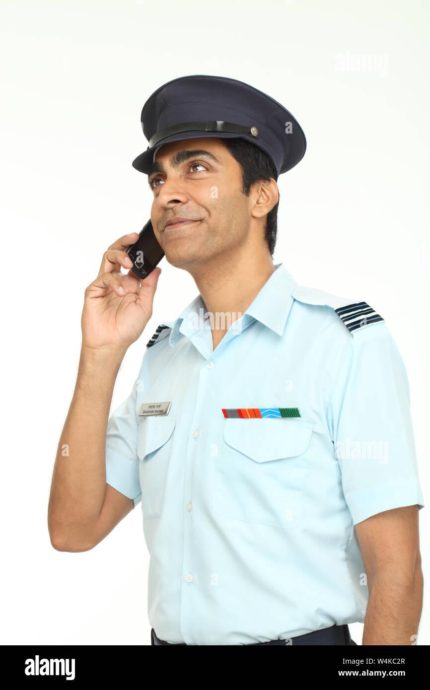 Pilot talking on a mobile phone Stock Photo - Alamy