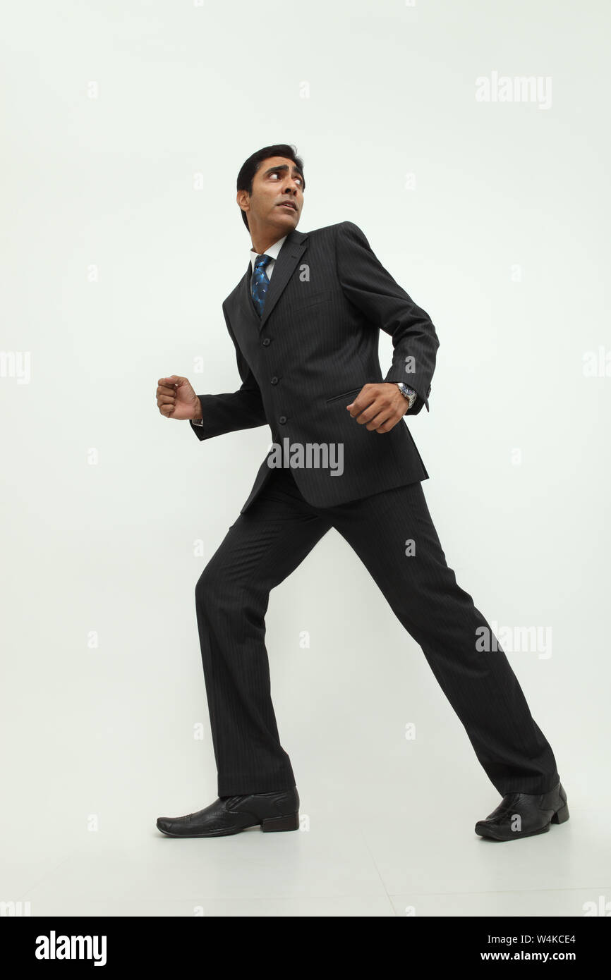 Indian businessman running in fear Stock Photo - Alamy