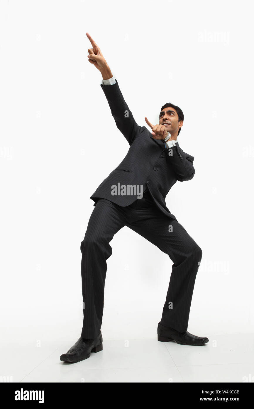 Indian businessman pretending to point gun Stock Photo - Alamy
