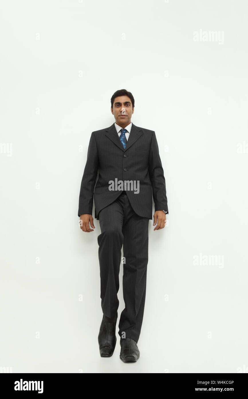 Indian business man standing against wall hi-res stock photography and ...