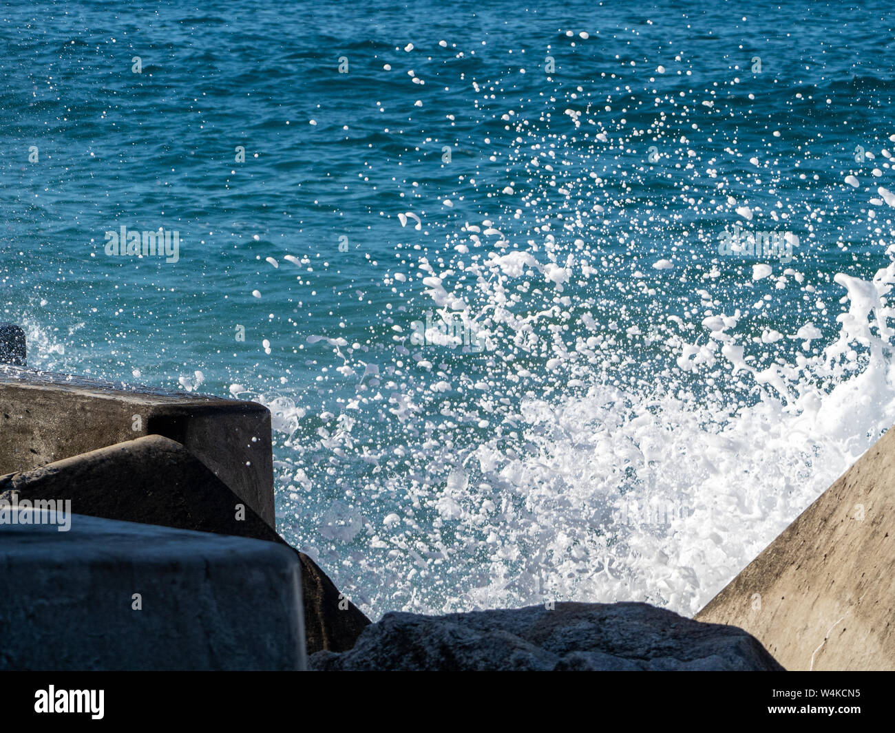 Water splashing against concrete blocks Stock Photo - Alamy