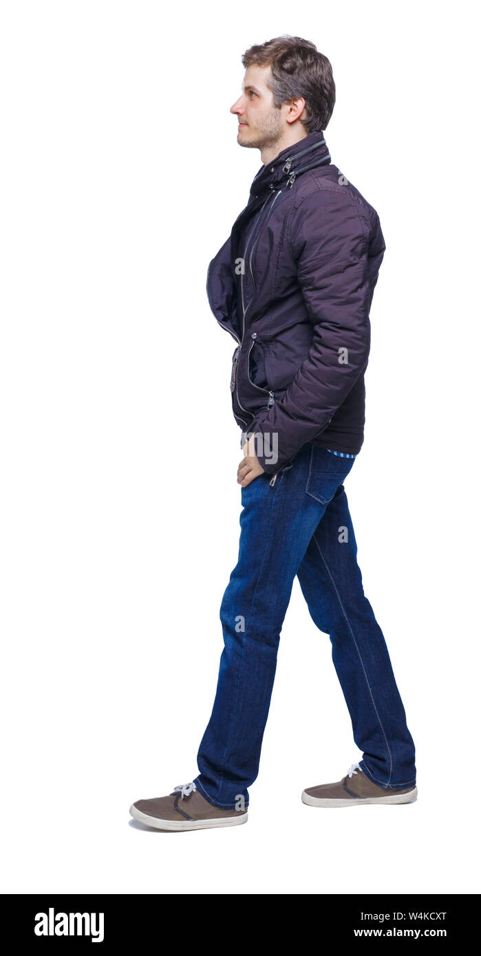 Side view of going handsome man in jeans and jacket. walking young guy ...