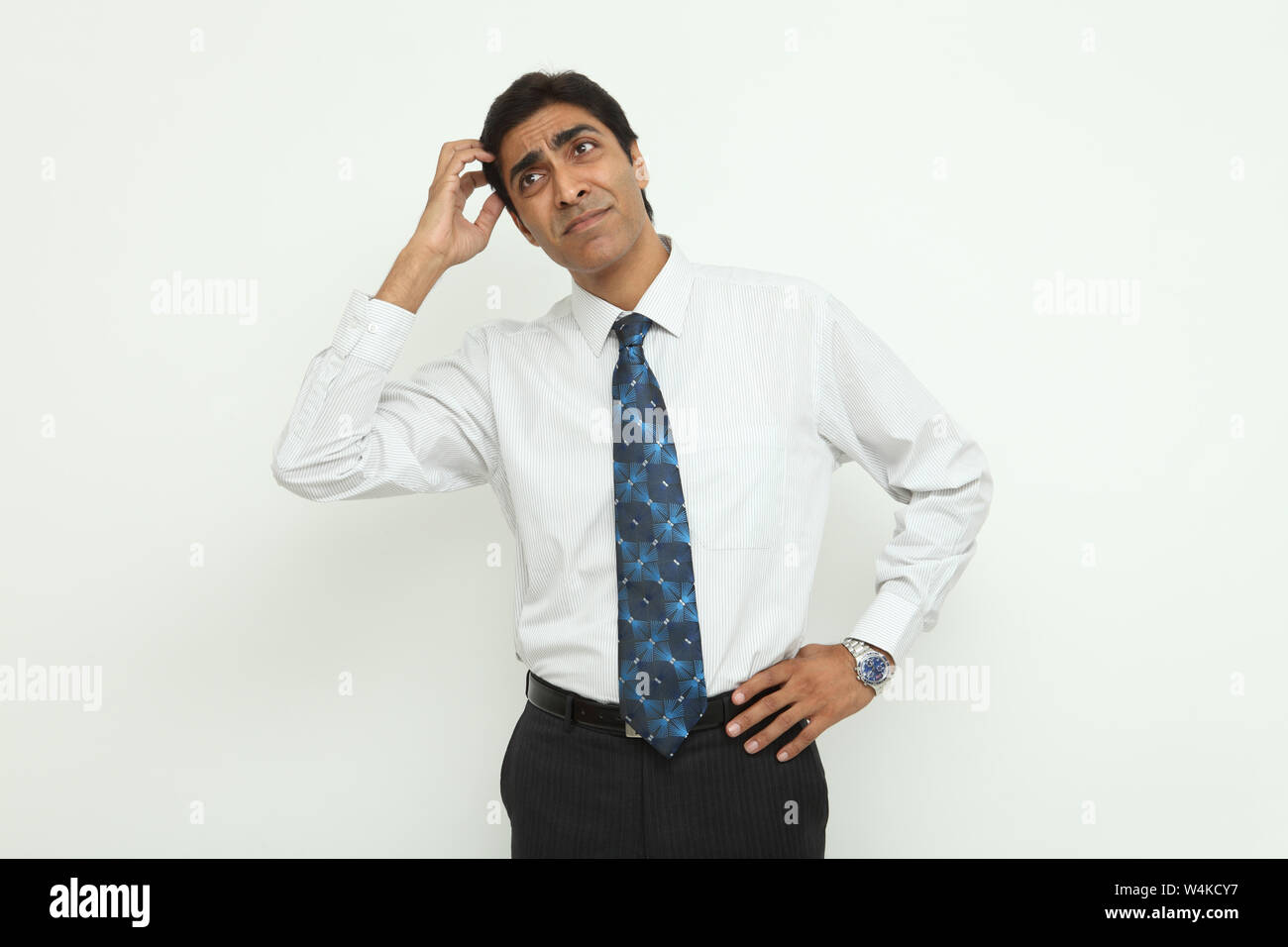 Indian businessman scratching head hi-res stock photography and images ...