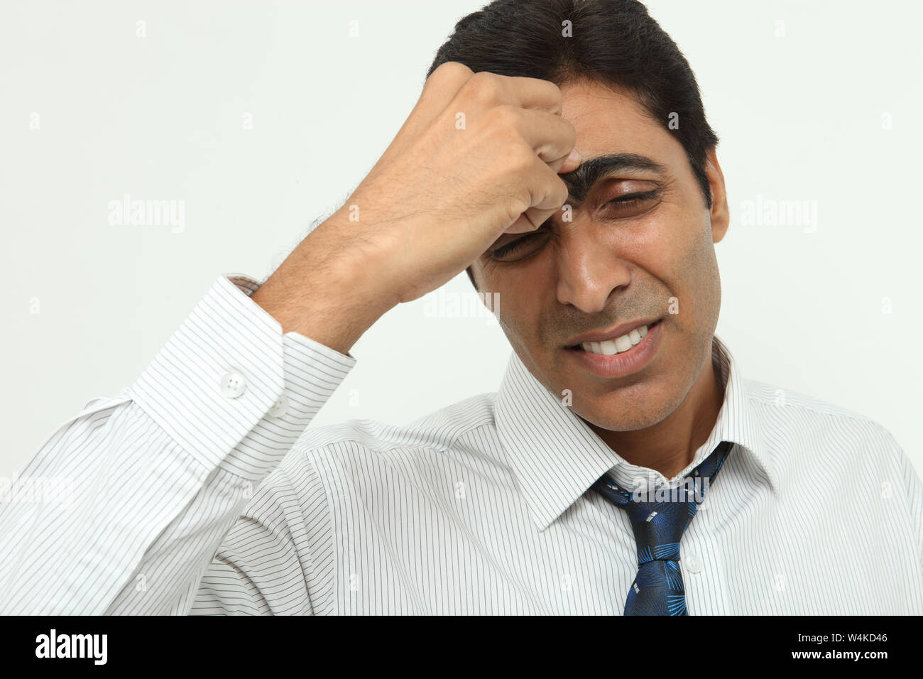 Indian businessman suffering from headache Stock Photo - Alamy