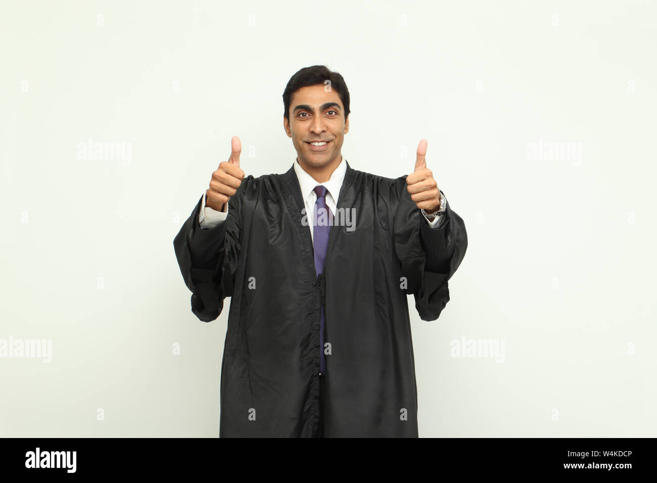 Lawyer showing thumbs up sign and smiling Stock Photo - Alamy
